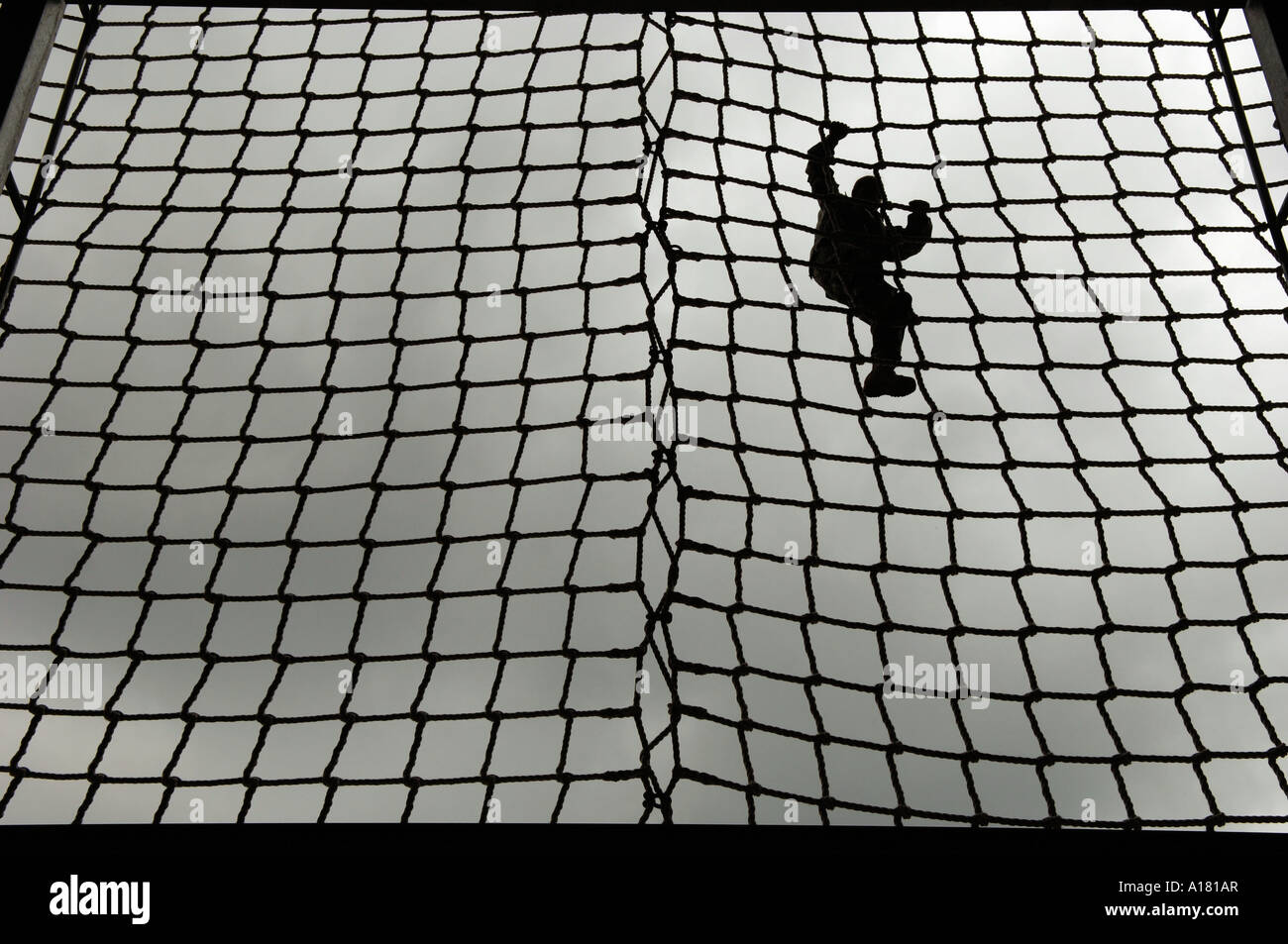 A U.S. Army Soldier-in-training makes her way down the rope ladder at ...