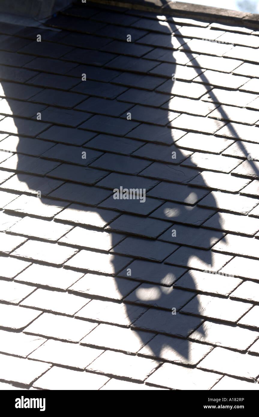THE SHADOW OF A CHIMNEY STACK CASTS A SEEMINGLY DEMONIC SHADOW ACROSS A ...