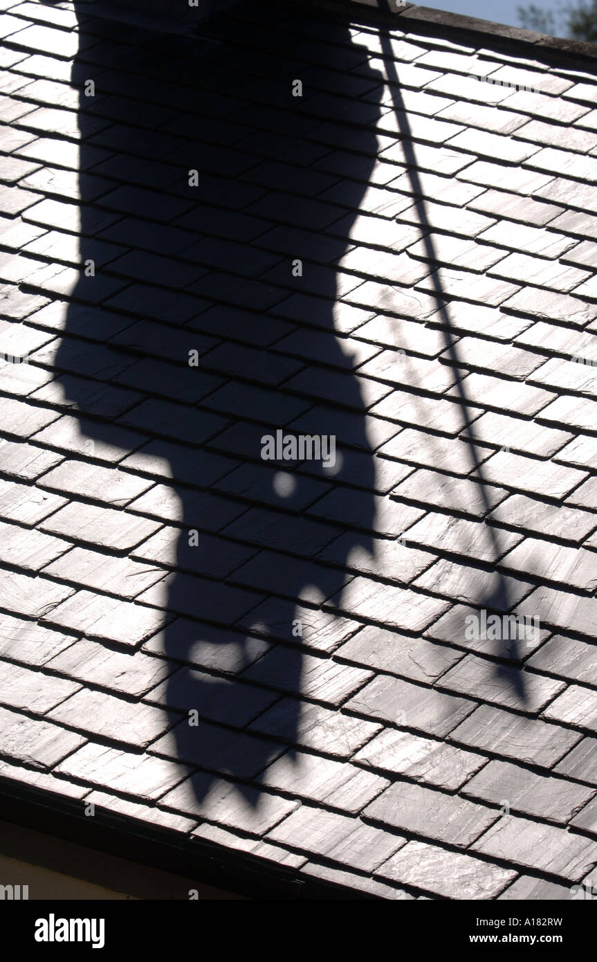 THE SHADOW OF A CHIMNEY STACK CASTS A SEEMINGLY DEMONIC SHADOW ACROSS A ...