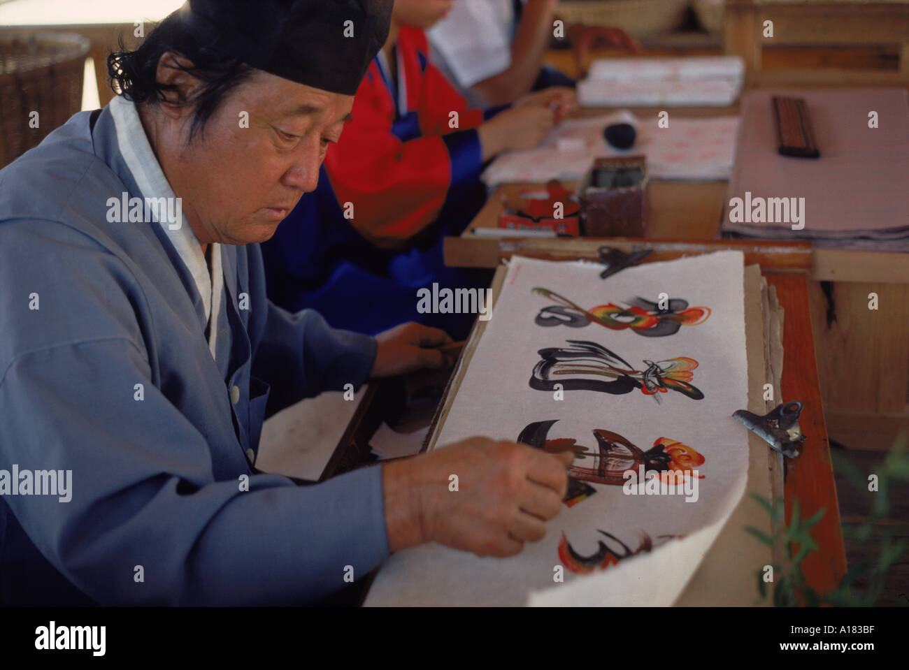 Portrait of a caligrapher at work painting letters in South Korea Asia ...