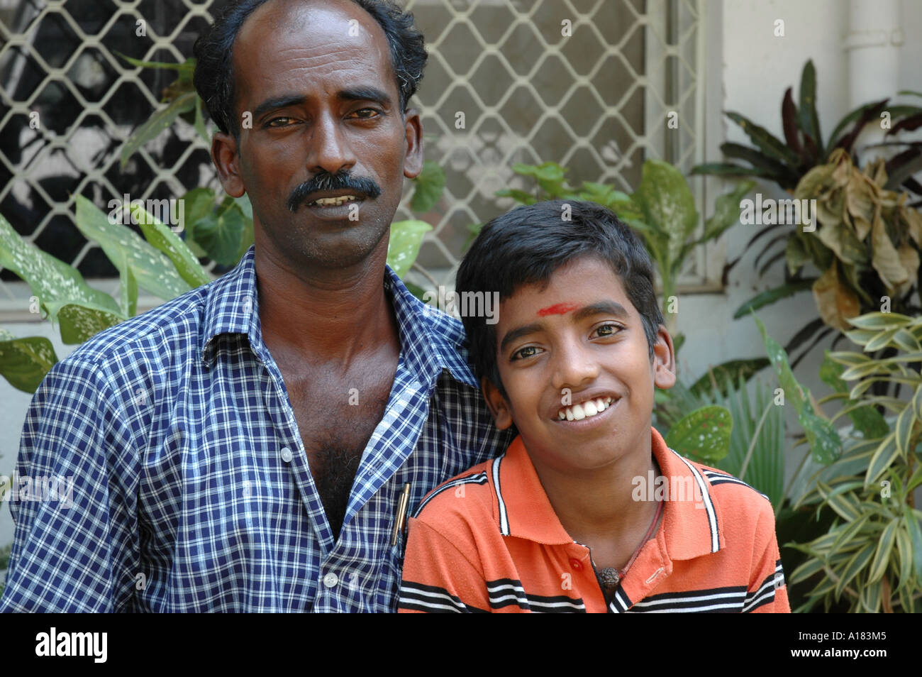 A young boy with his father in India Stock Photo - Alamy