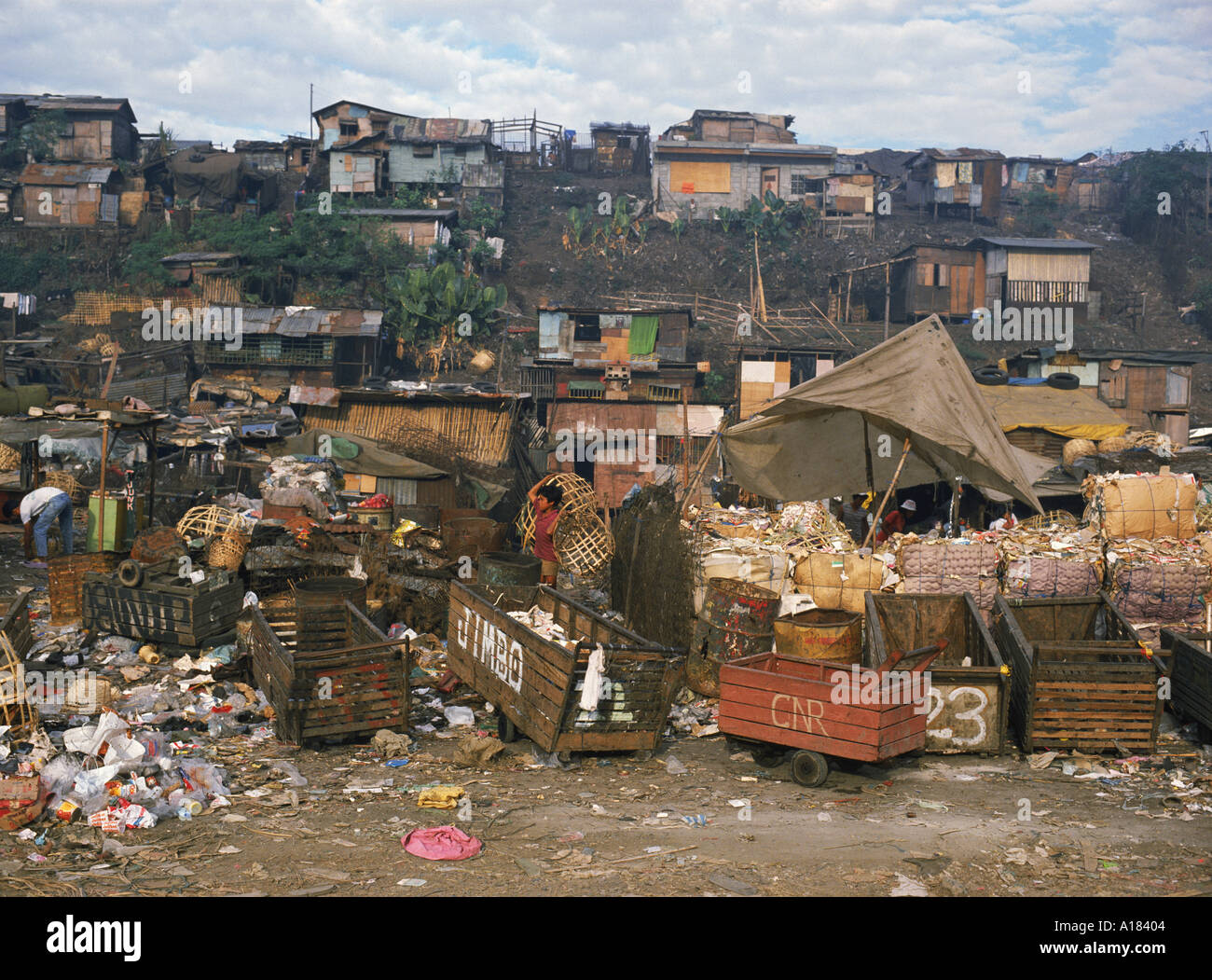 People living and working collecting rubbish from piles on reclaimed ...
