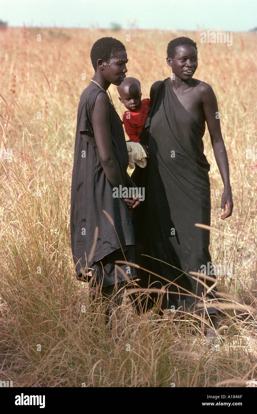Two Shilluk women one holding child Sudan Africa F J Jackson Stock ...