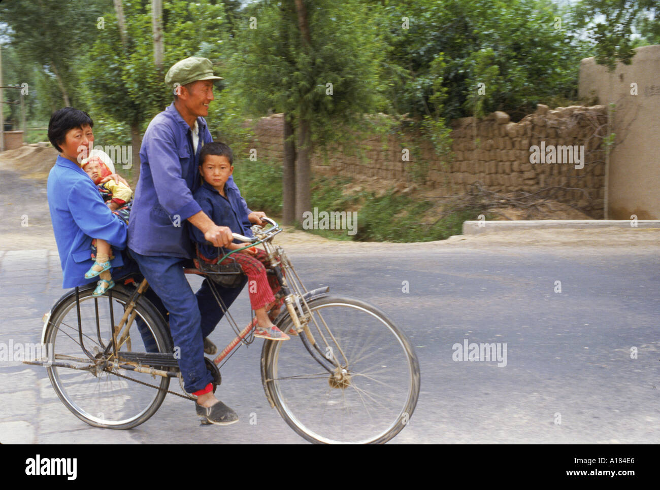 Family riding on a bicycle in Ningxia China R Hanbury Tenison Stock ...