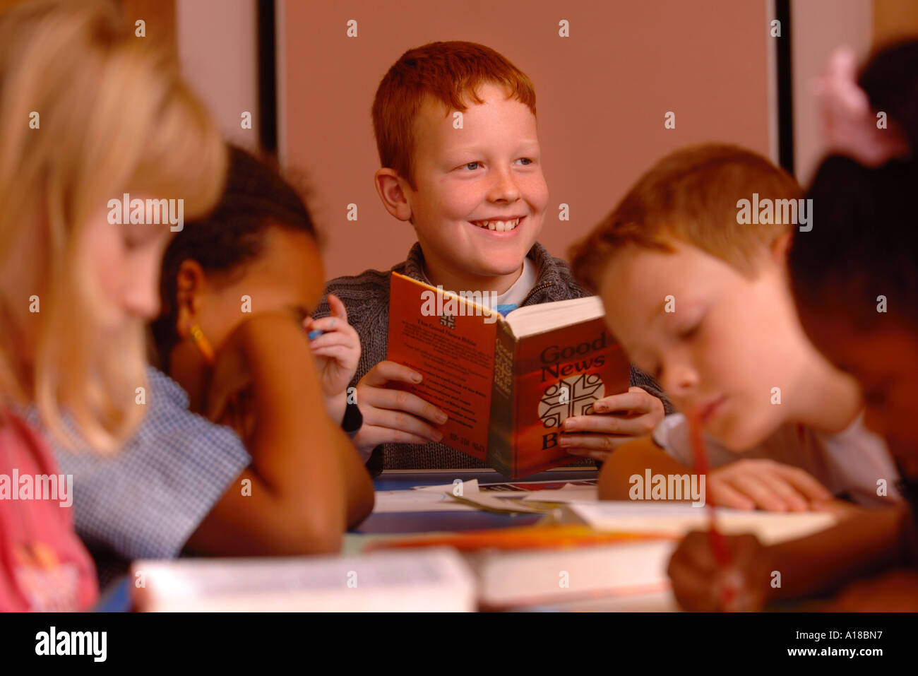 CHILDREN READING BIBLES AND COLOURING IN DRAWINGS AT A SUNDAY SCHOOL UK ...