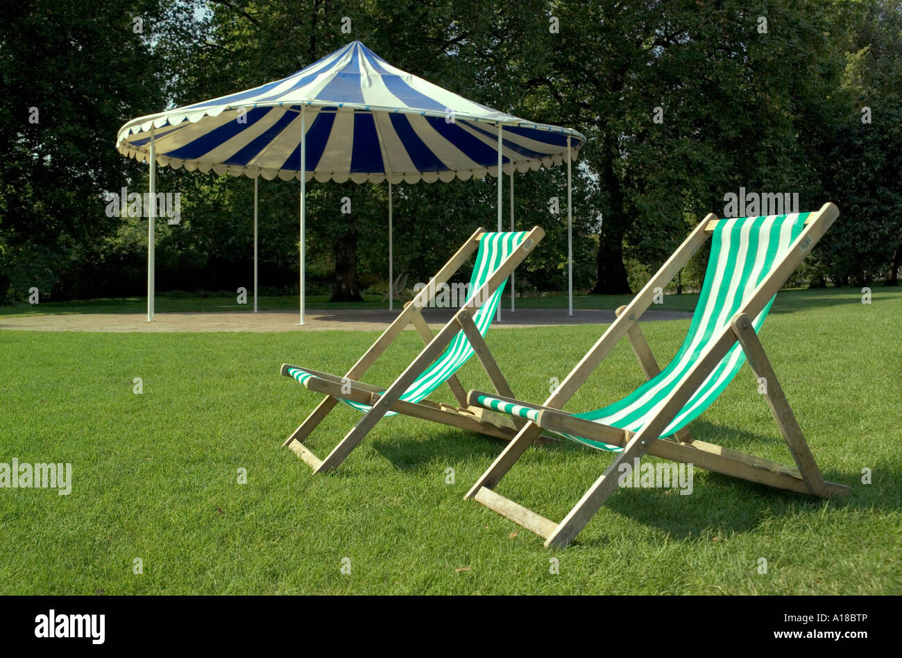 two empty deck chairs in a park Stock Photo - Alamy