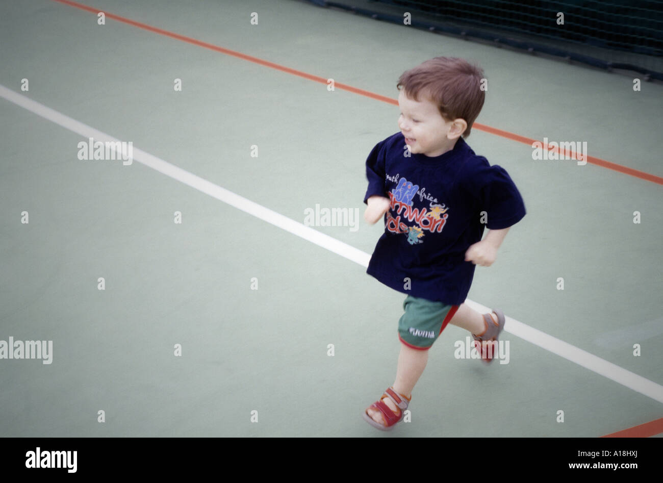 a young boy running Stock Photo - Alamy