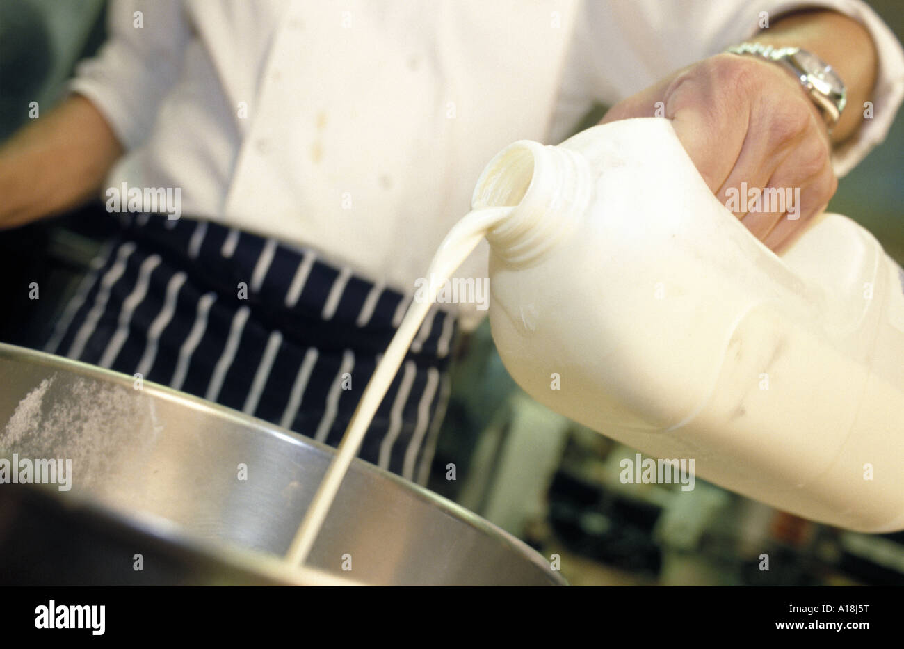 a chef pours milk into a dish Stock Photo - Alamy
