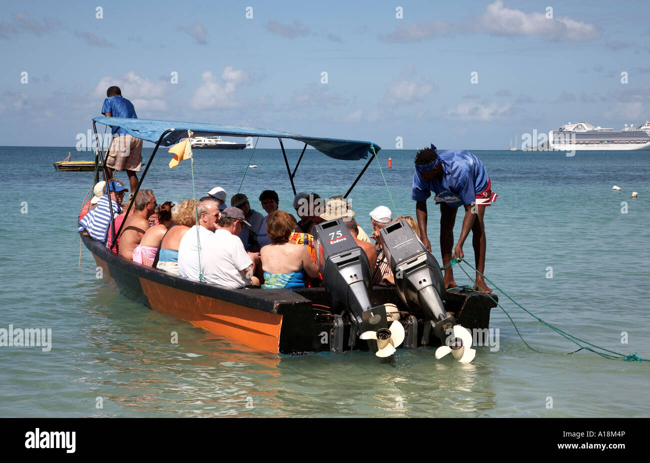 tourists aboard the water taxi on grand anse beach st. george's grenada ...