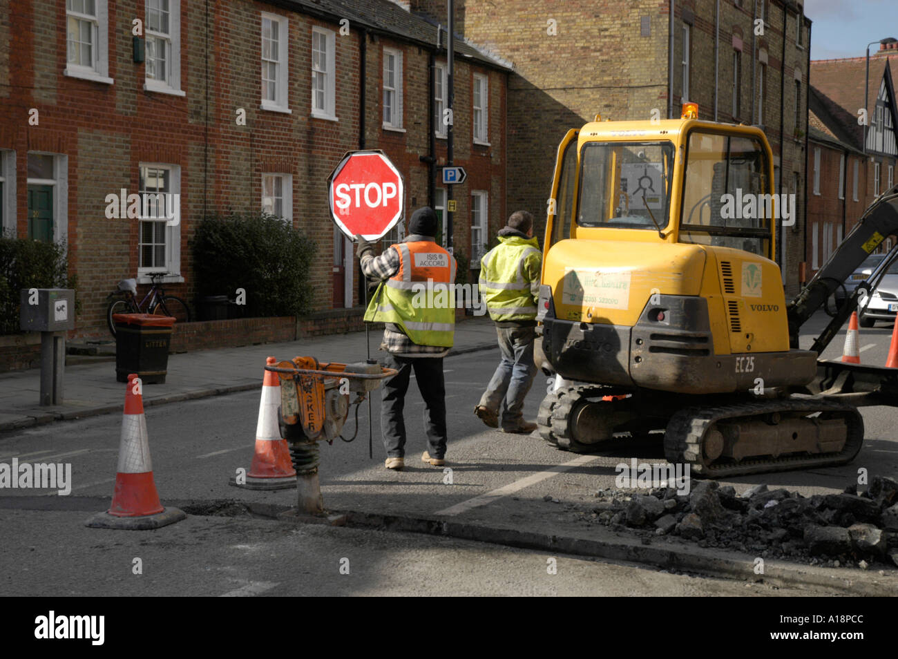 stop go sign and workers at road works Stock Photo - Alamy