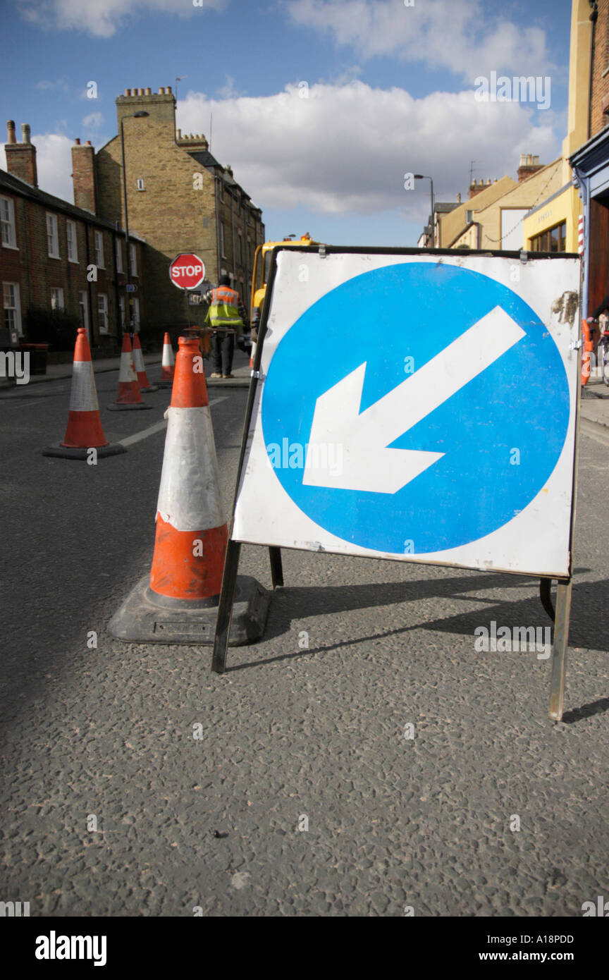 Keep left sign and workers at road works Stock Photo - Alamy