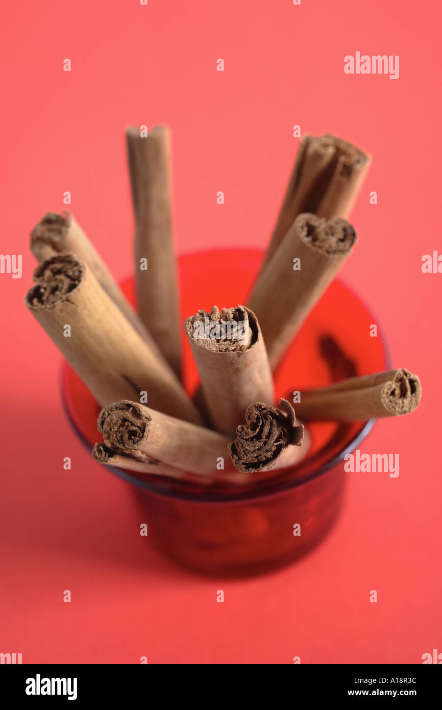 Cinnamon Sticks in Red Glass Stock Photo - Alamy