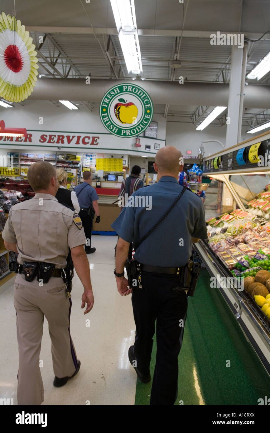Police officers walking to back room to apprehend a suspect that had ...