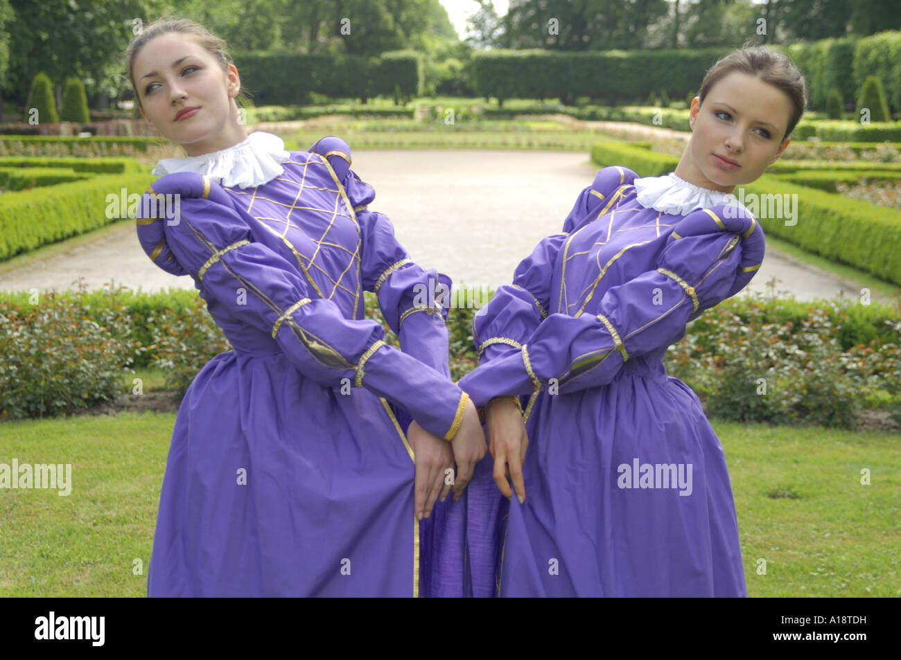 Young Polish ballet dancers in blue dresses in a country garden setting ...