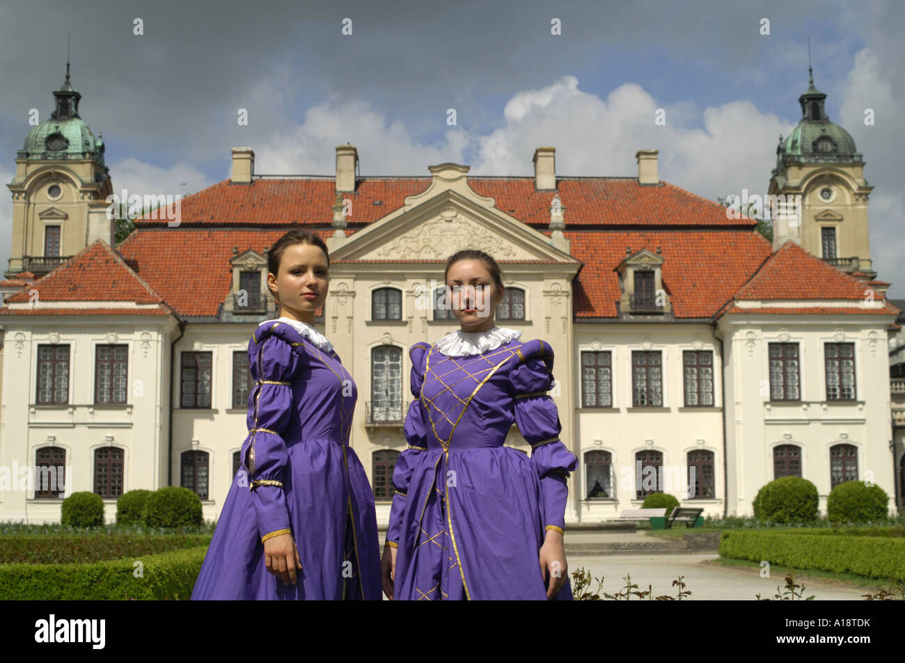 Young Polish ballet dancers in blue dresses in a country garden setting ...