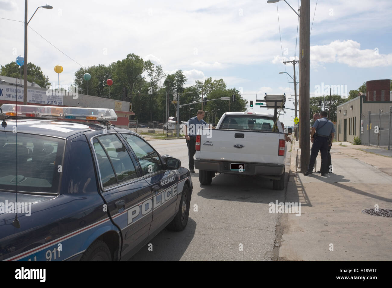 Police officers talking to driver and passenger in a vehicle stopped ...