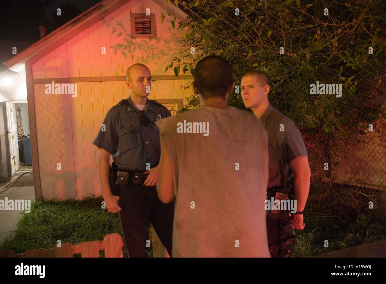 Police officers interviewing victim at the scene of a burglary and ...