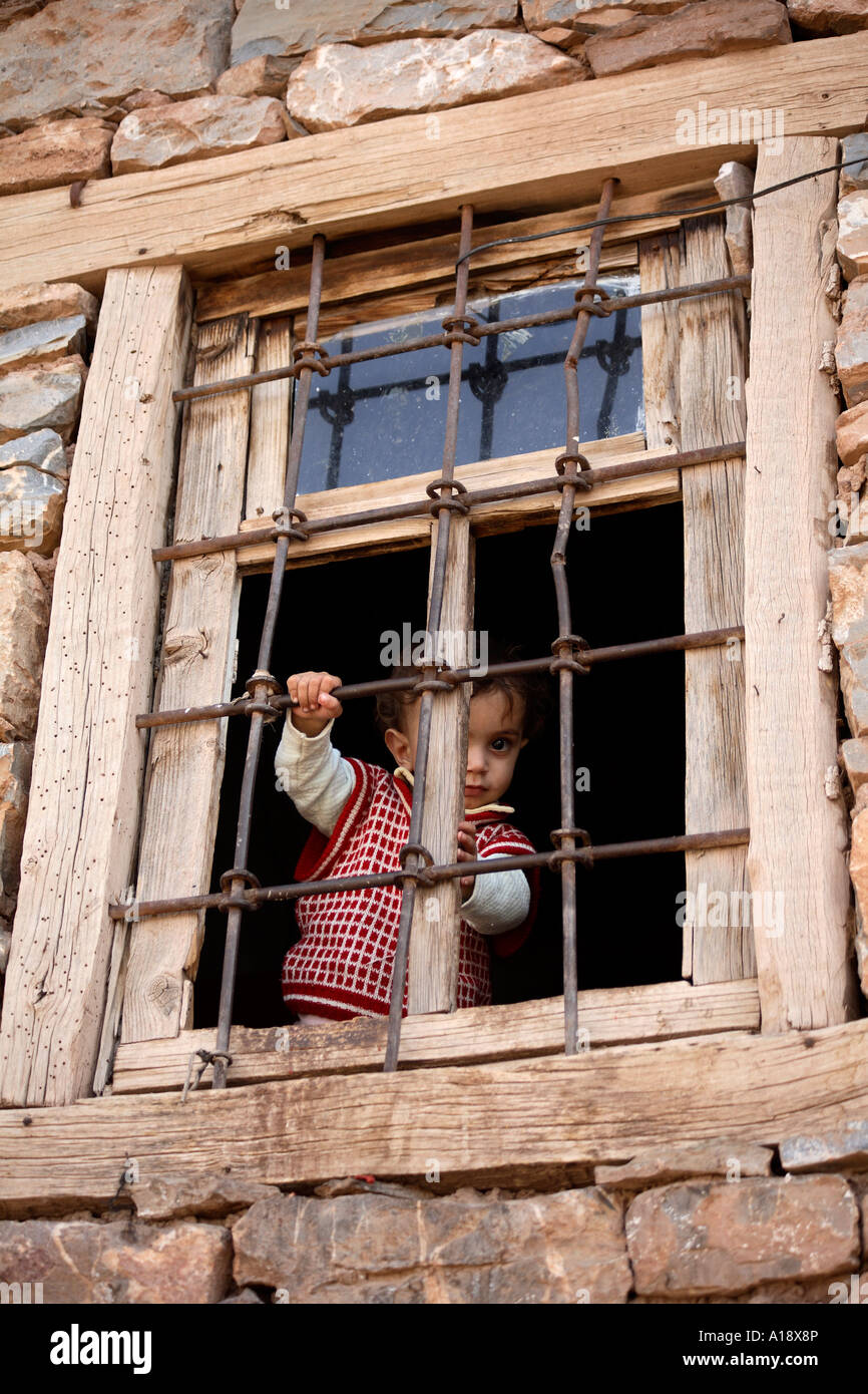 Young child looking out of barred window. Village in Eastern Turkey ...