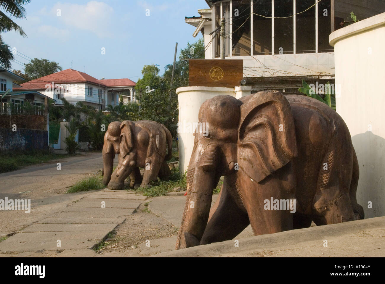 Two huge teak wood elephants guard the entrance to a family home Golden ...