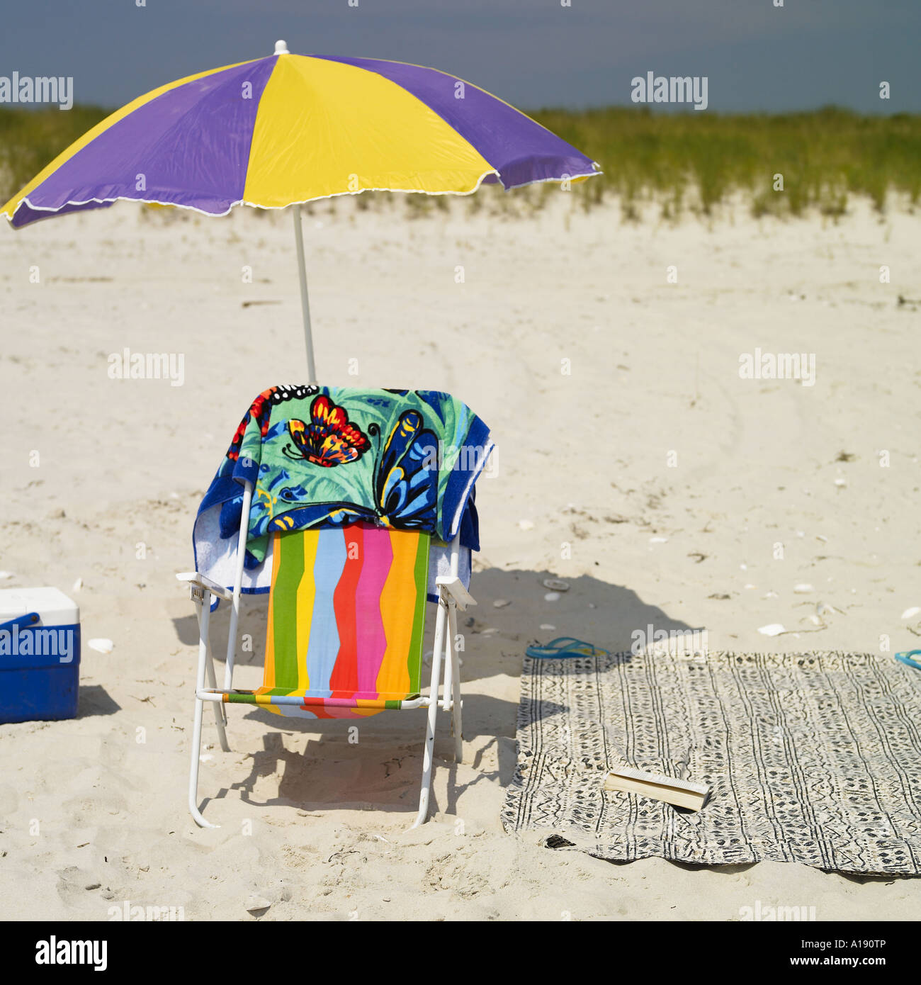 Multi-colored umbrella on a beach Stock Photo - Alamy