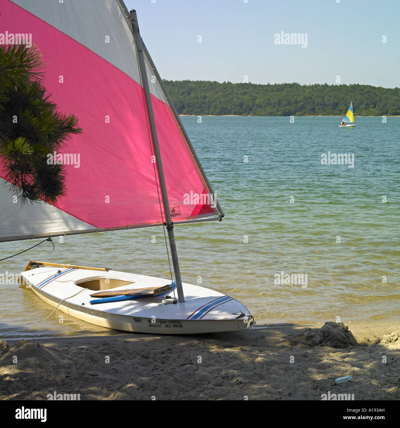 Small boat with colorful sail Stock Photo - Alamy