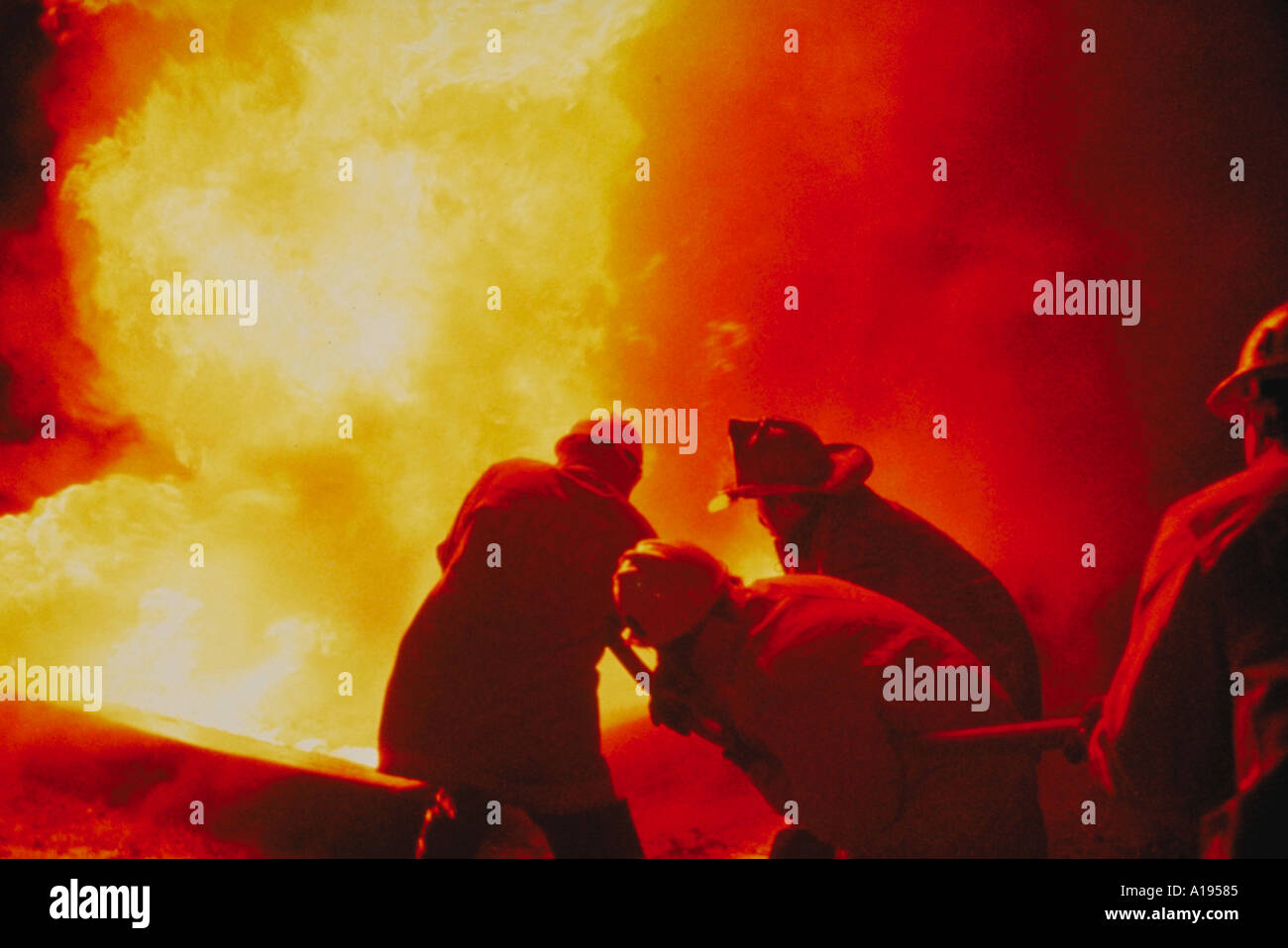 Firefighters fighting fire Stock Photo - Alamy