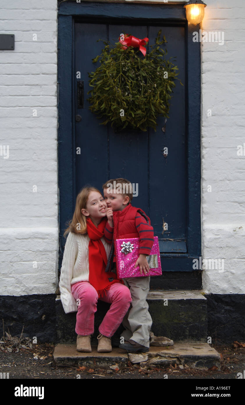 Kissing under the Mistletoe.Old door with Mistletoe display.Christmas ...
