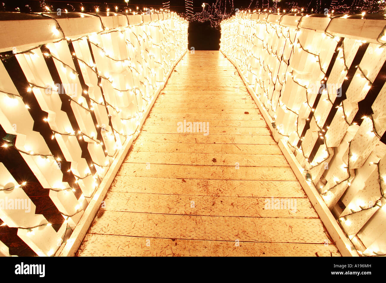 A bridge lit with christmas lights at night Stock Photo - Alamy
