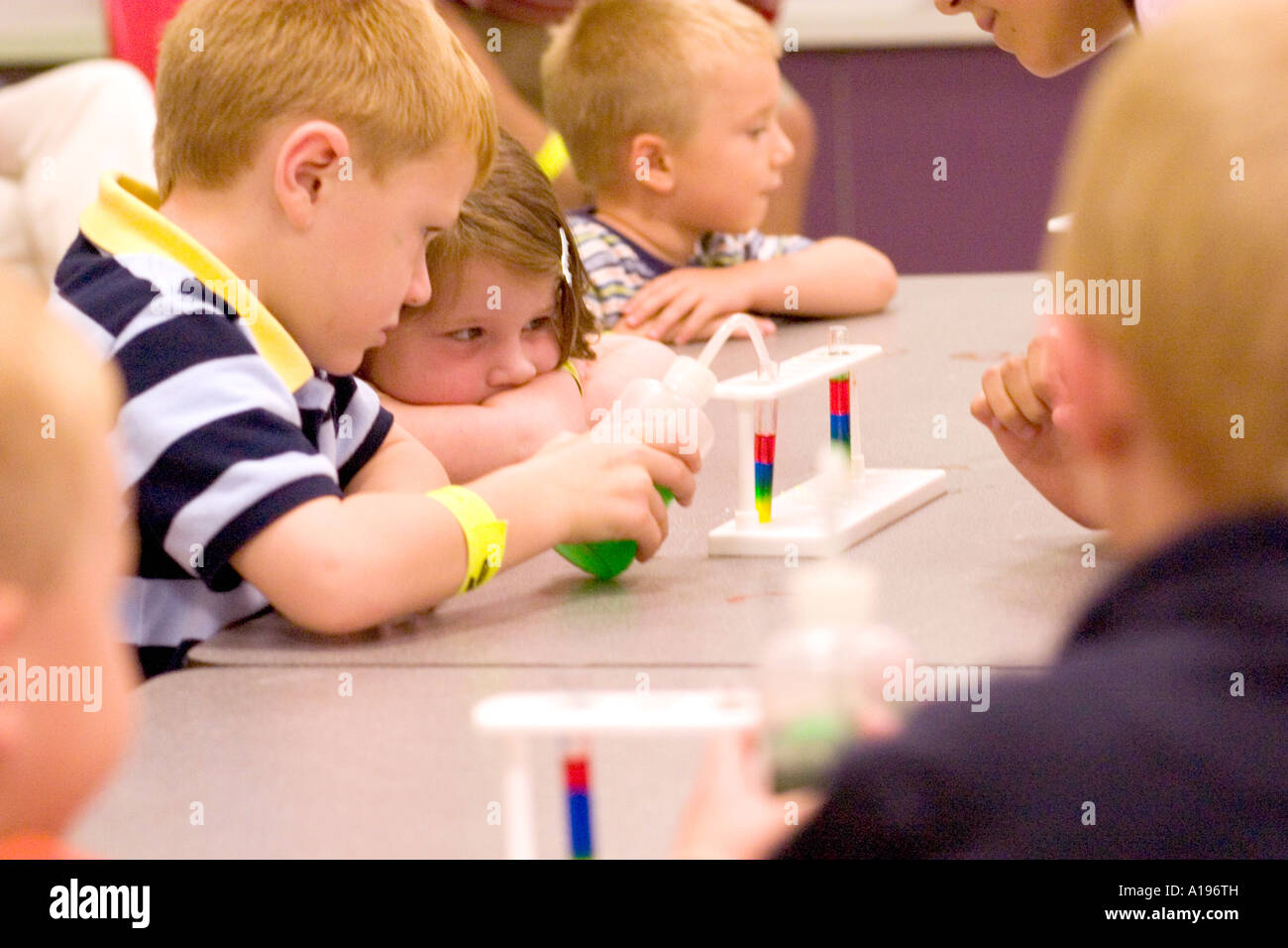 Kids testing color weight in test tubes at the Science Museum school ...