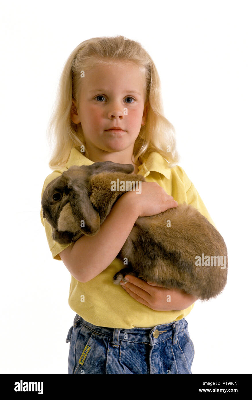 Blond girl with a rabbit in her arms Stock Photo - Alamy