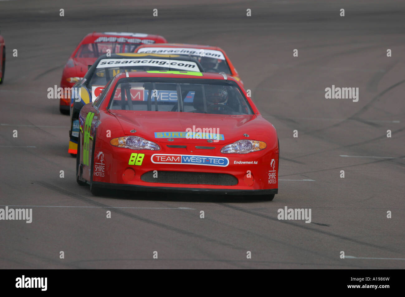 V8 Nascar type stock cars racing on a banked oval circuit Stock Photo ...