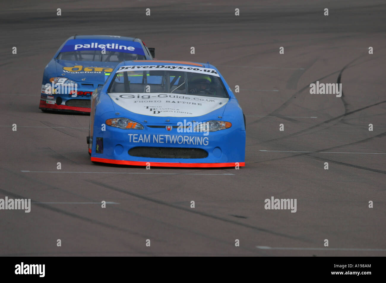 V8 Nascar type stock cars racing on a banked oval circuit Stock Photo ...