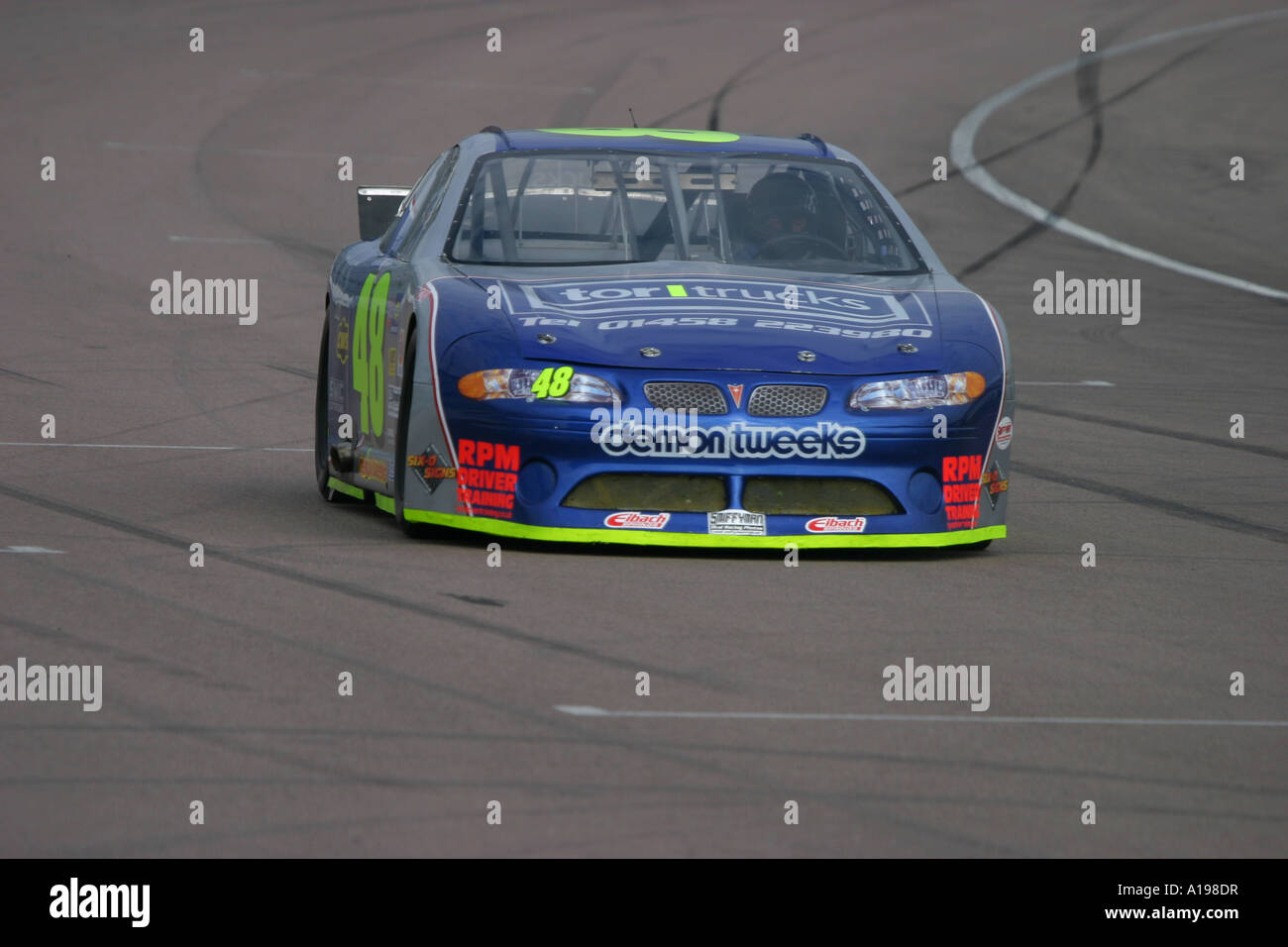 V8 Nascar type stock cars racing on a banked oval circuit Stock Photo ...