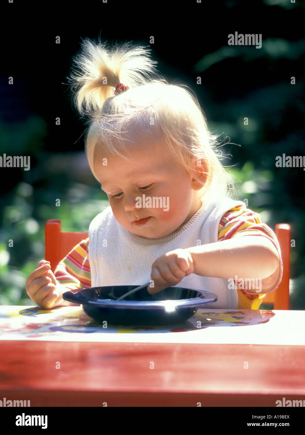 Little girl eating herself Stock Photo - Alamy