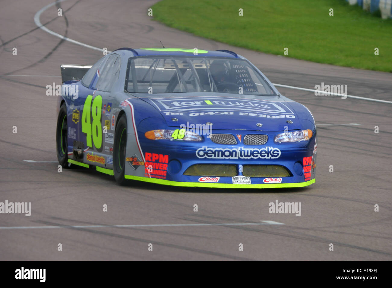 V8 Nascar type stock cars racing on a banked oval circuit Stock Photo ...