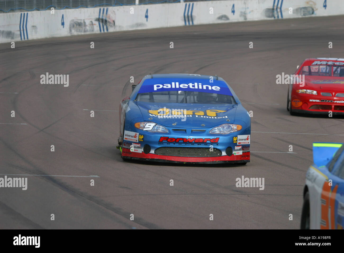 V8 Nascar type stock cars racing on a banked oval circuit Stock Photo ...