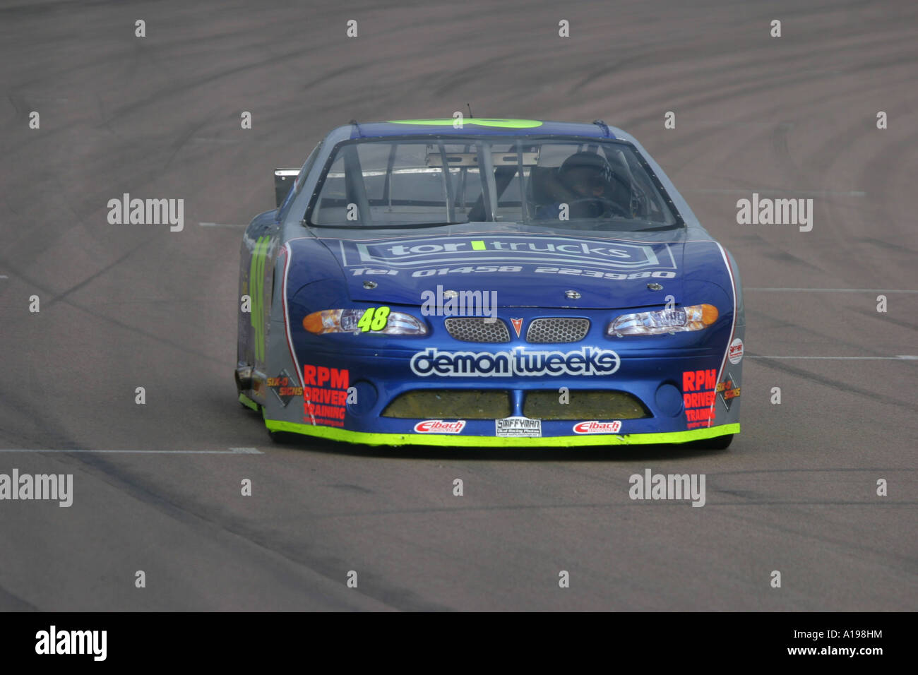 V8 Nascar type stock cars racing on a banked oval circuit Stock Photo ...