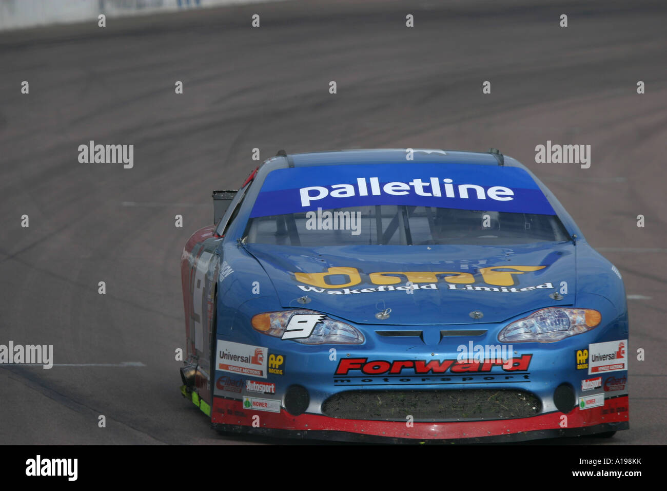 V8 Nascar type stock cars racing on a banked oval circuit Stock Photo ...