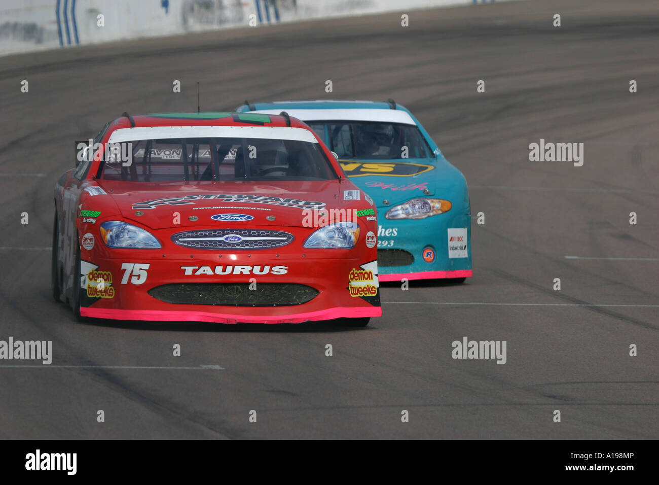 V8 Nascar type stock cars racing on a banked oval circuit Stock Photo ...