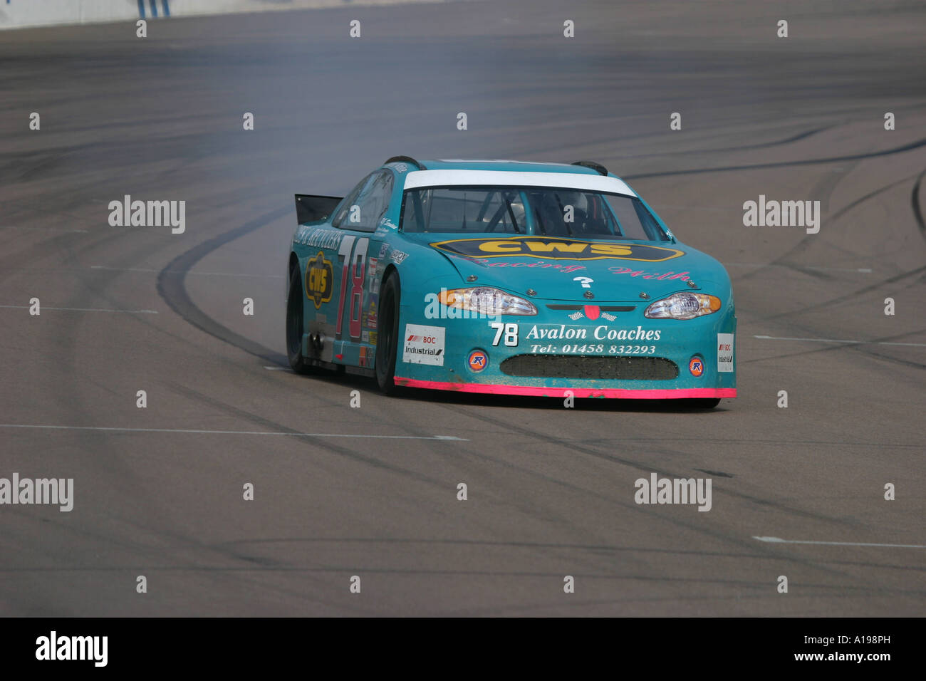 V8 Nascar type stock cars racing on a banked oval circuit Stock Photo ...