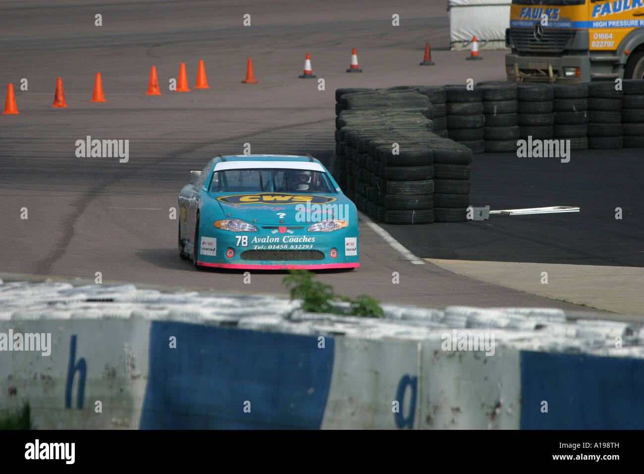 V8 Nascar type stock cars racing on a banked oval circuit Stock Photo ...