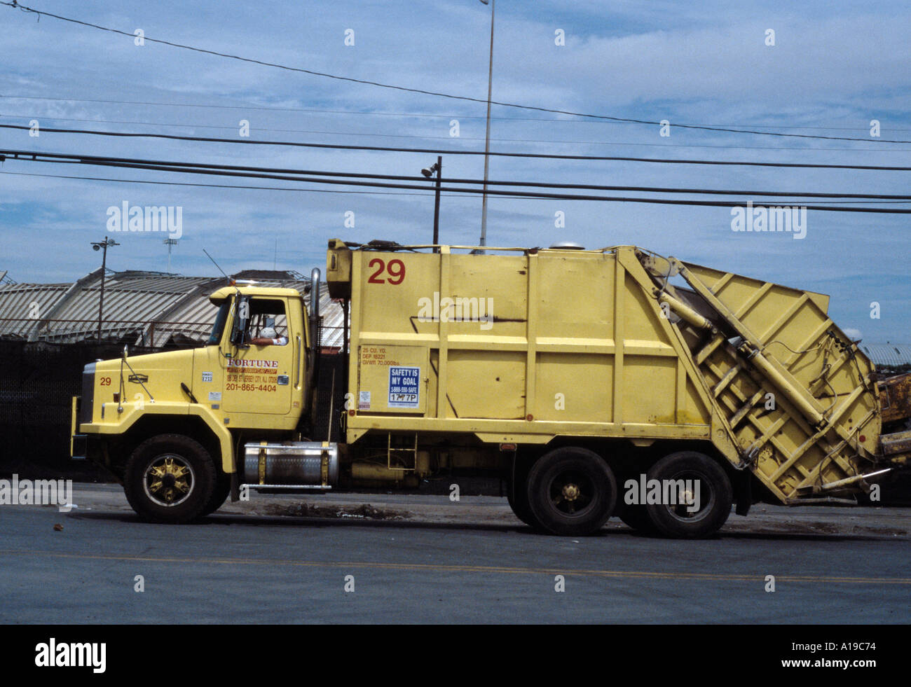 Yellow Garbage Truck Stock Photo - Alamy