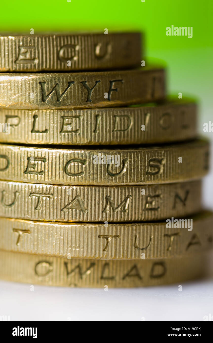 One Pound coins on white and green background Stock Photo - Alamy