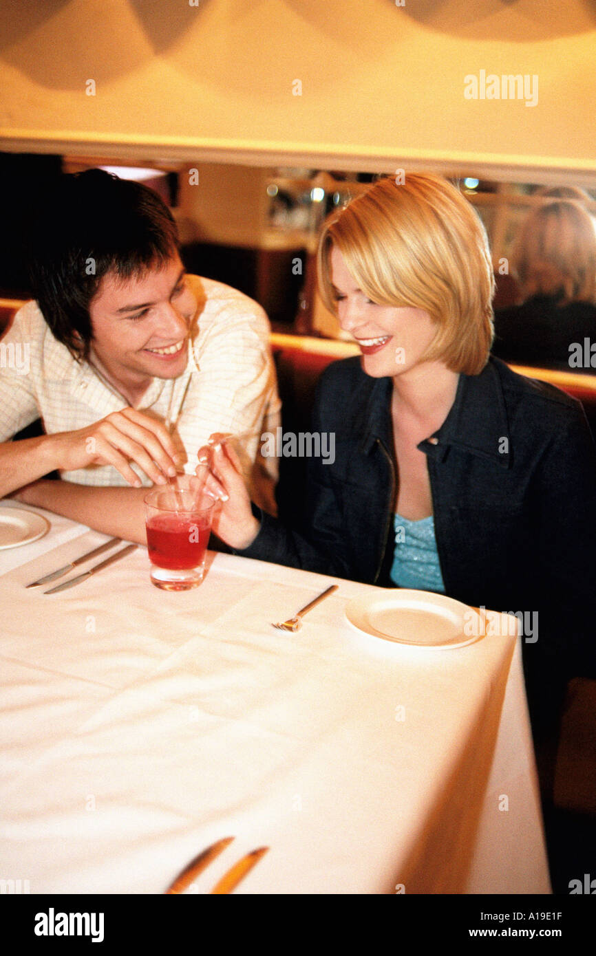 Couple talking at a restaurant table Stock Photo - Alamy