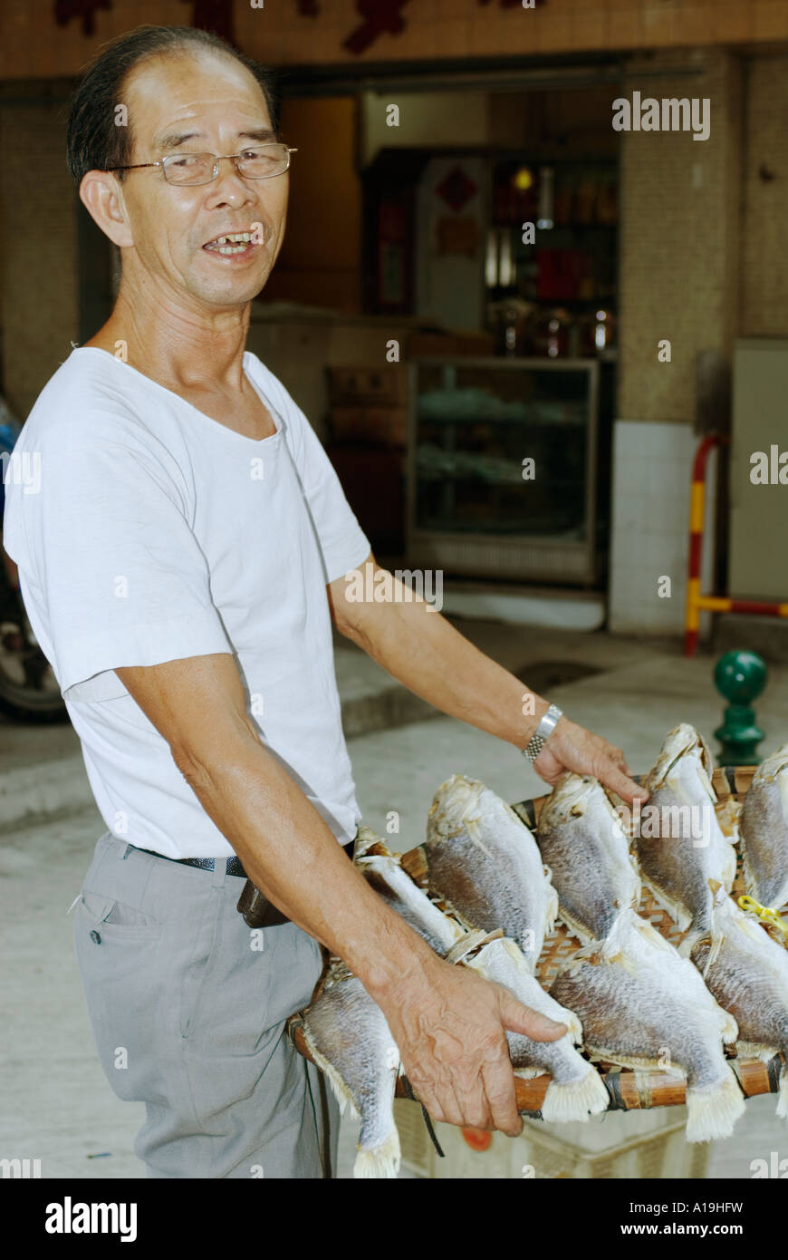 Macau Man Selling Dried Fish China Stock Photo - Alamy