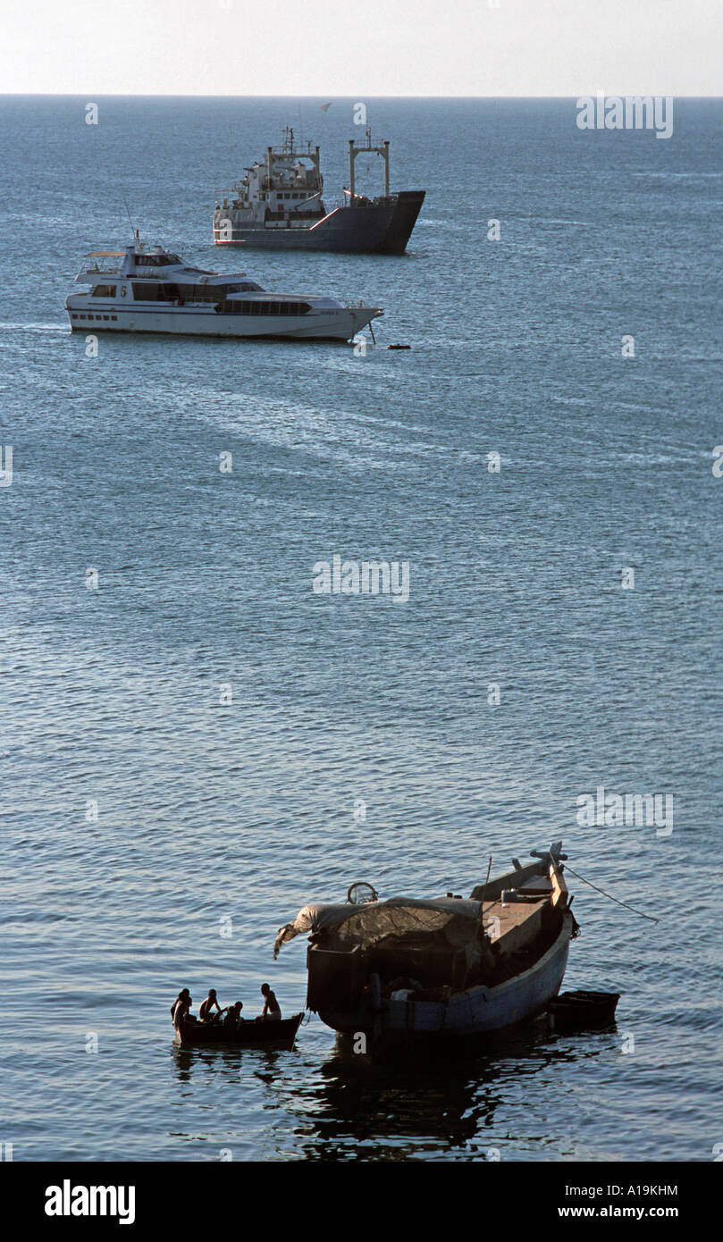 Silhouetted boats in Stone Town harbour in the late afternoon Unguja ...