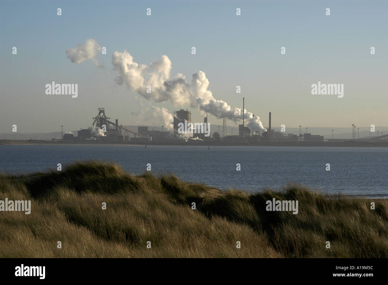 View of Tata steelworks across Tees Mouth with white smoke coming from ...