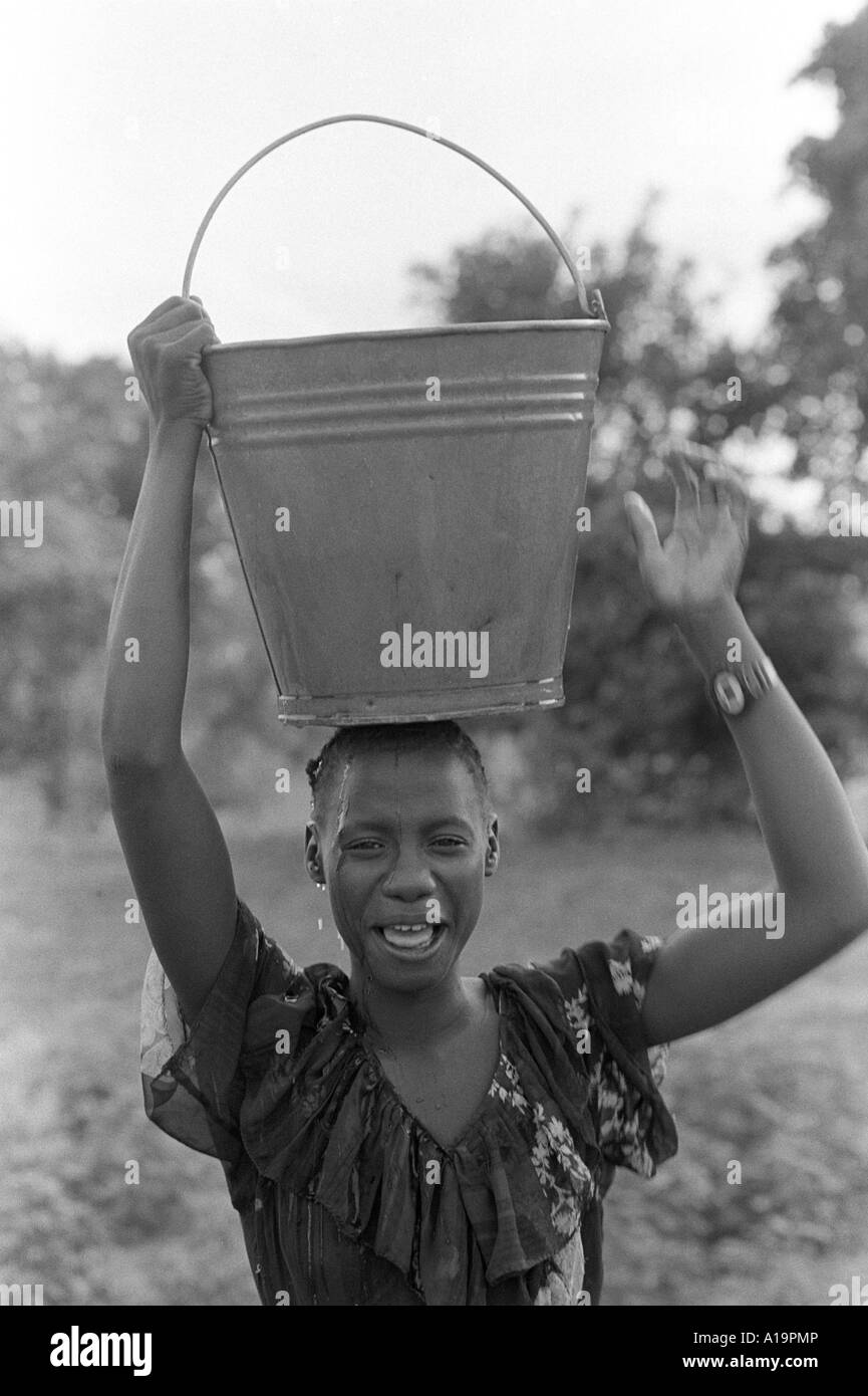 Woman carrying a bucket Black and White Stock Photos & Images - Alamy