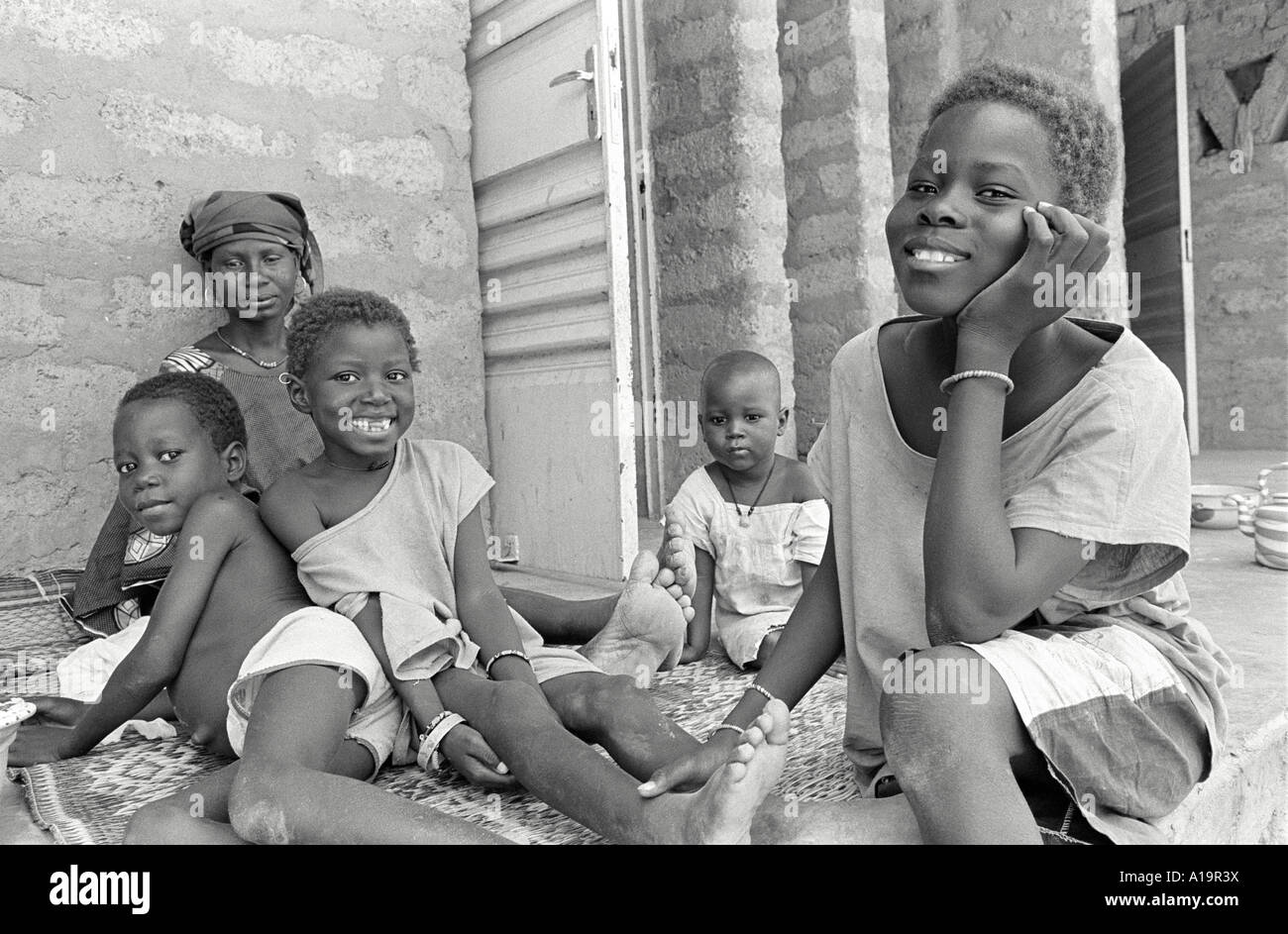 B/W of a mother and four children waiting outside to visit their father ...