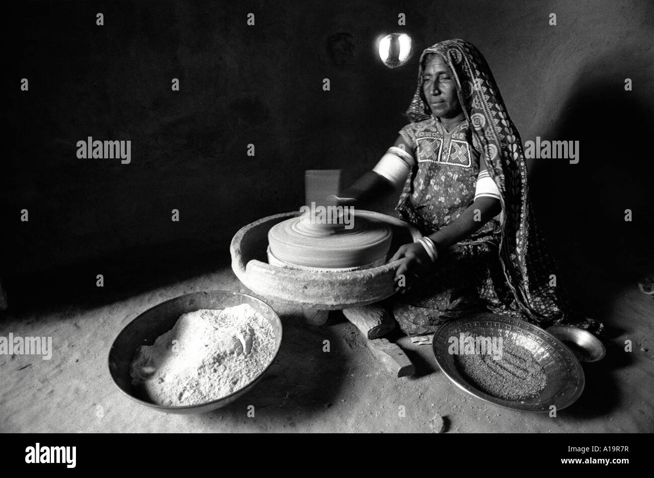 Grinding millet Black and White Stock Photos & Images - Alamy